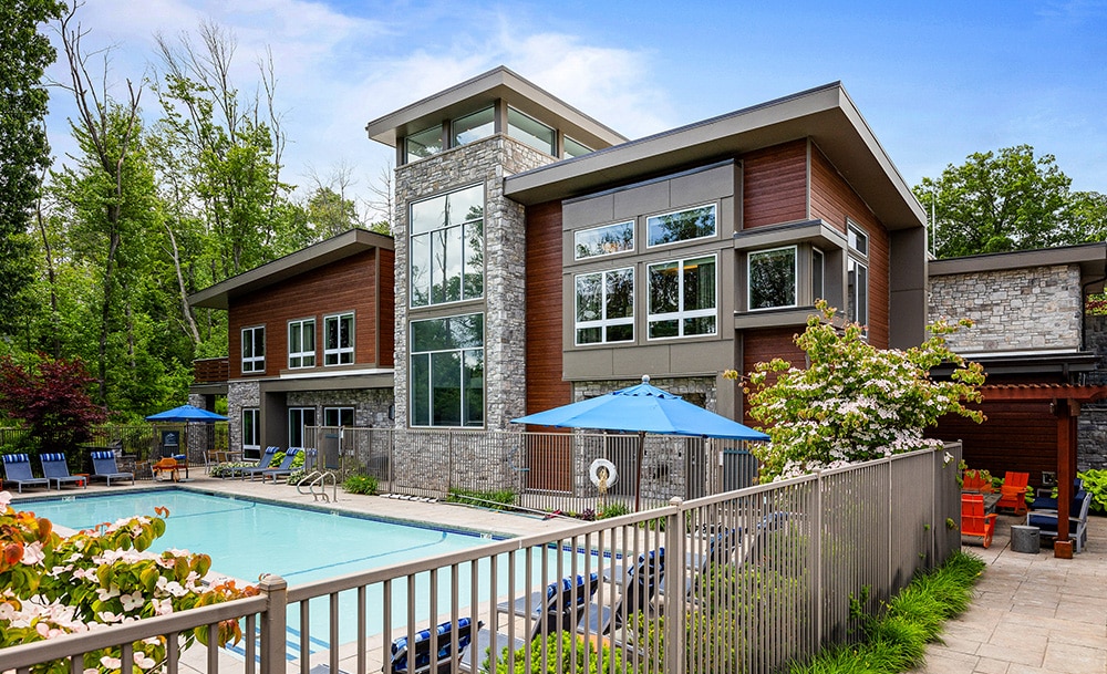 Poolside view of a luxury apartment pool and clubhouse