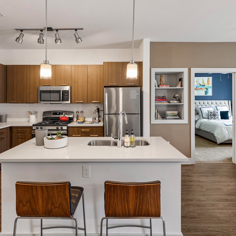 A luxe apartment with a kitchen island and built-in book shelves
